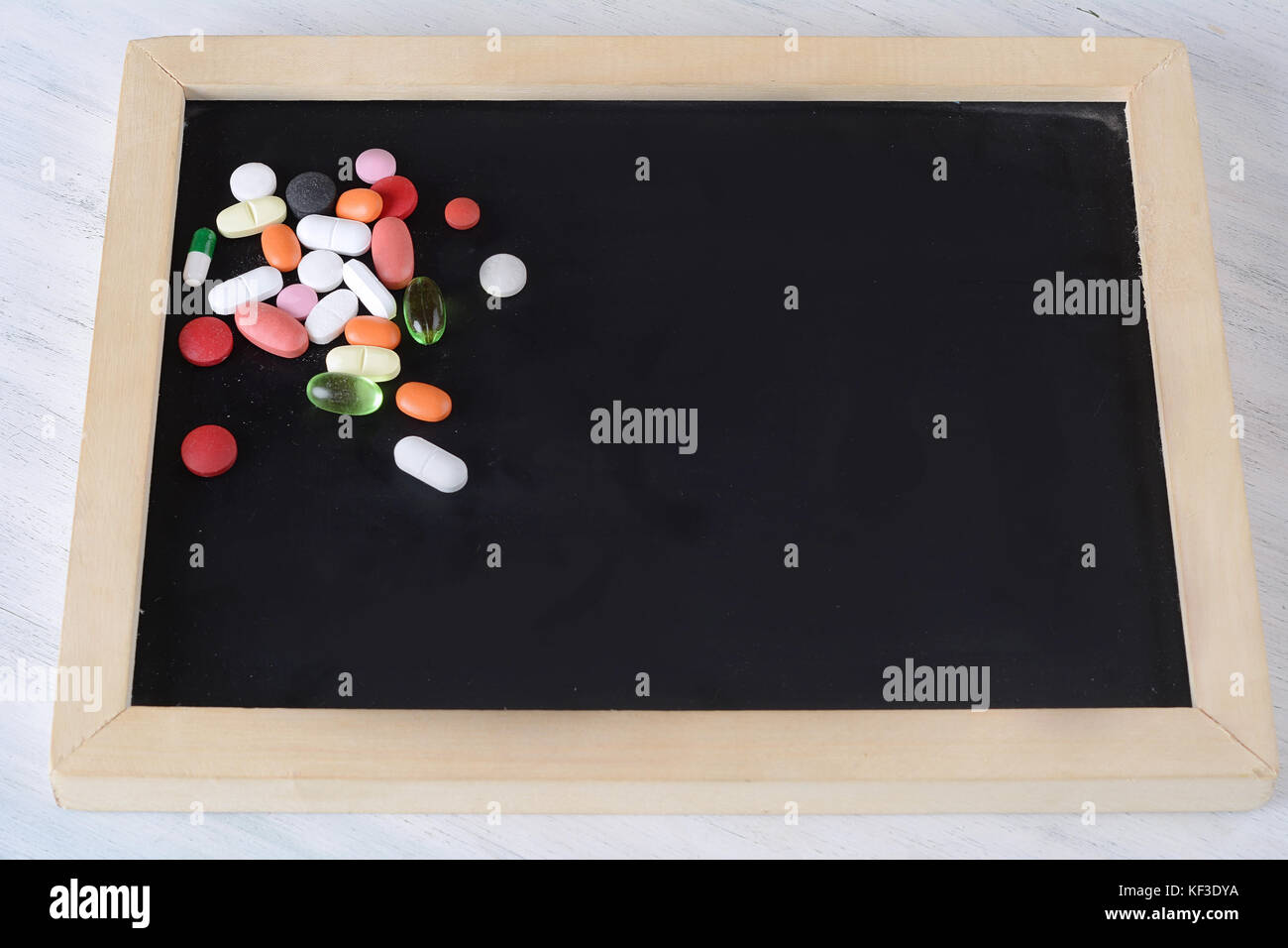 Close-up of empty chalkboard, pills and tablets. Healthcare concept ...
