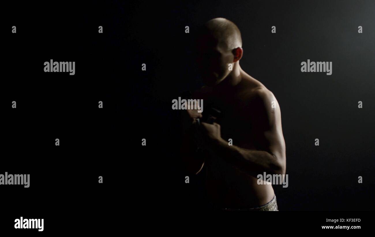 Fight with shadow on dark background. Fighter in studio. side view ...
