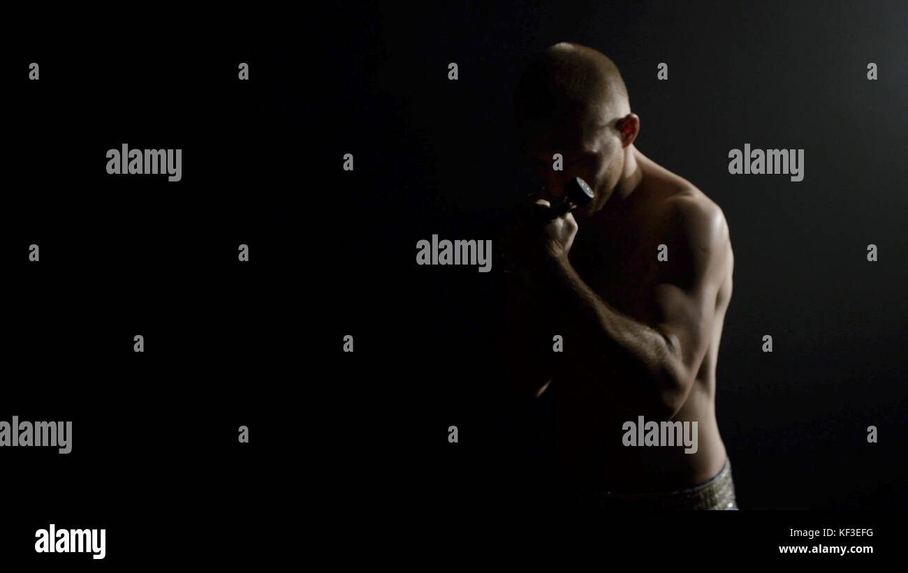Fight with shadow on dark background. Fighter in studio. side view ...