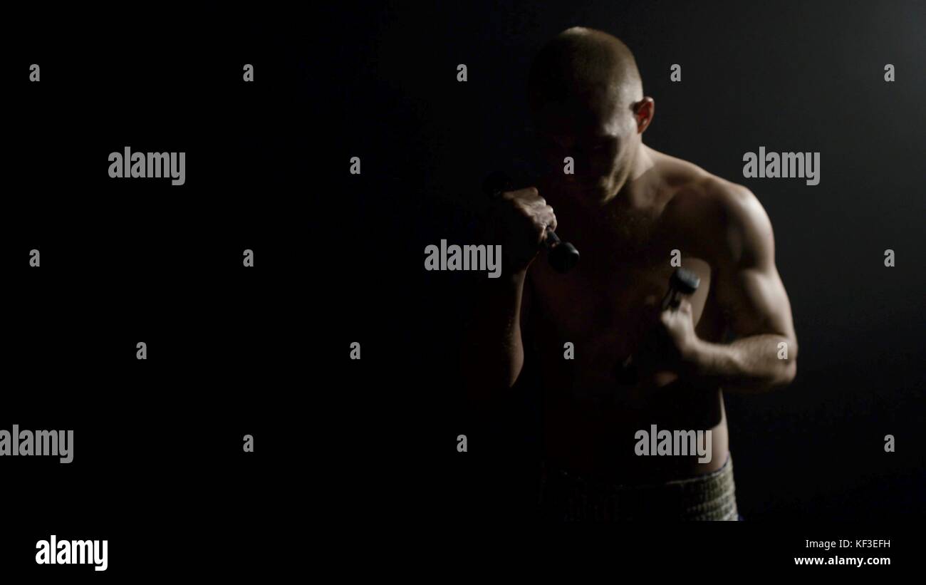 Fight with shadow on dark background. Fighter in studio. side view ...
