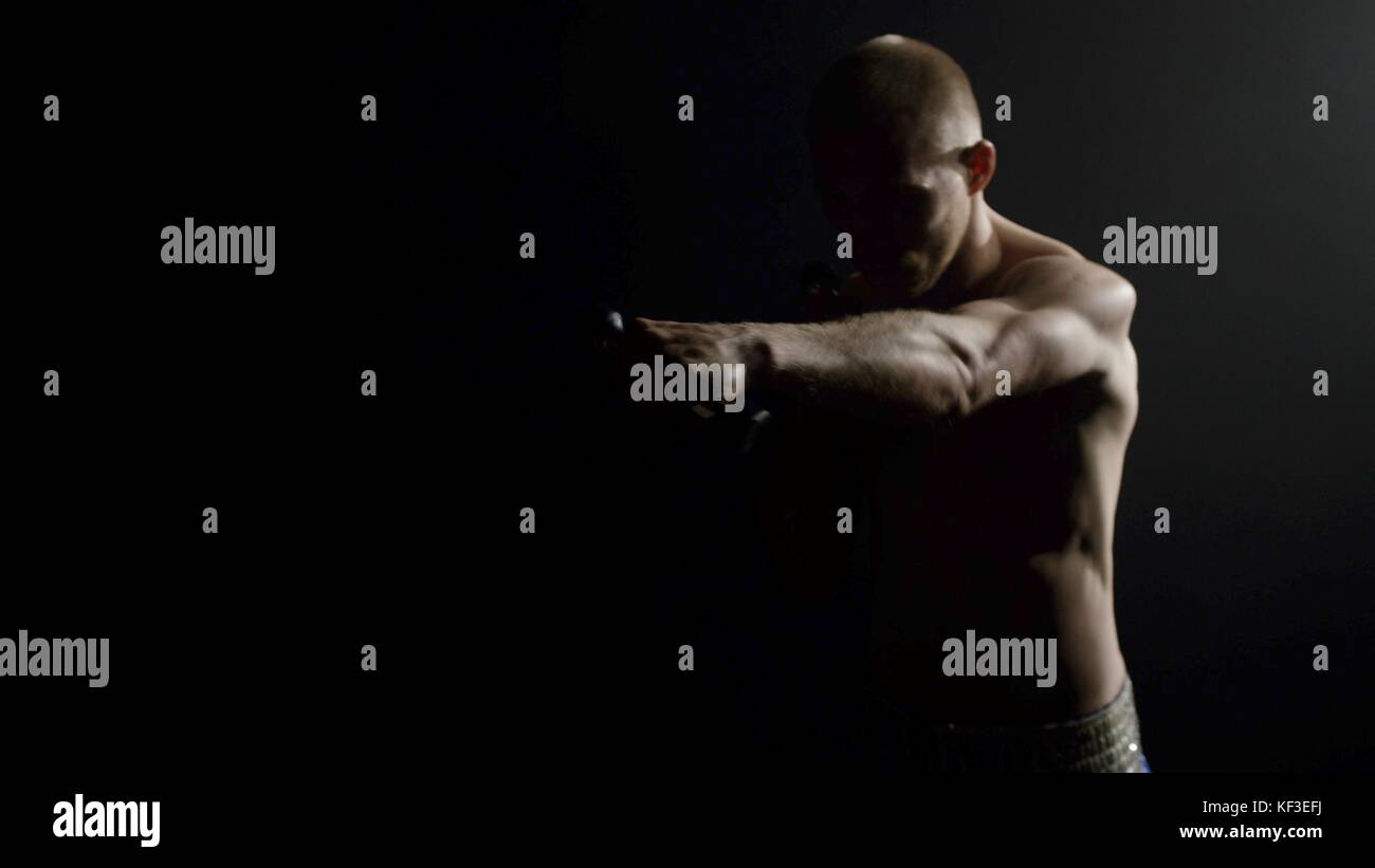 Fight with shadow on dark background. Fighter in studio. side view ...