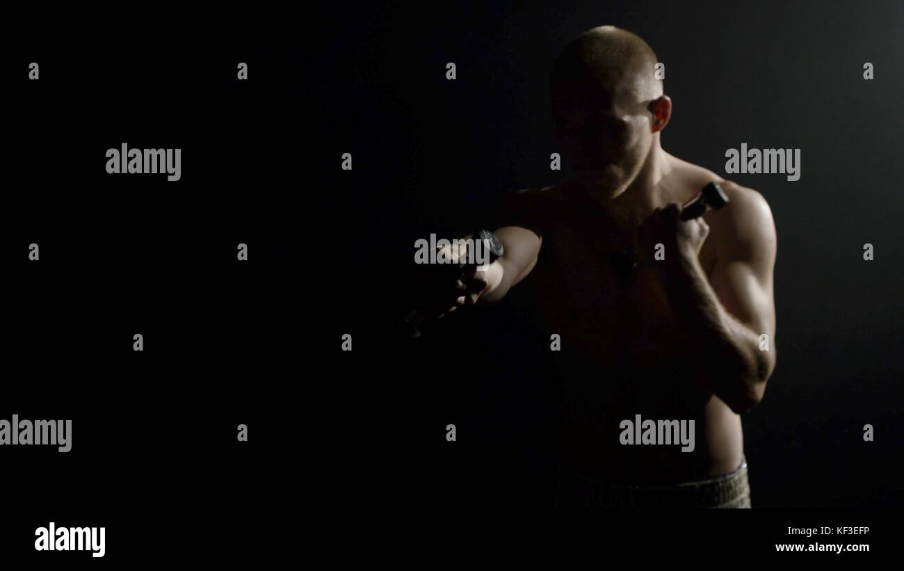 Fight with shadow on dark background. Fighter in studio. side view ...