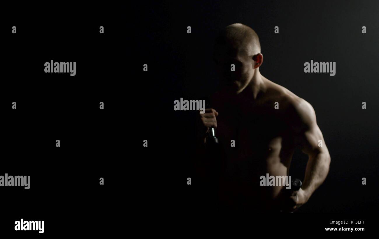 Fight with shadow on dark background. Fighter in studio. side view ...