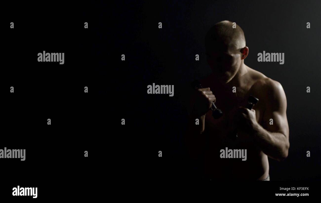 Fight with shadow on dark background. Fighter in studio. side view ...