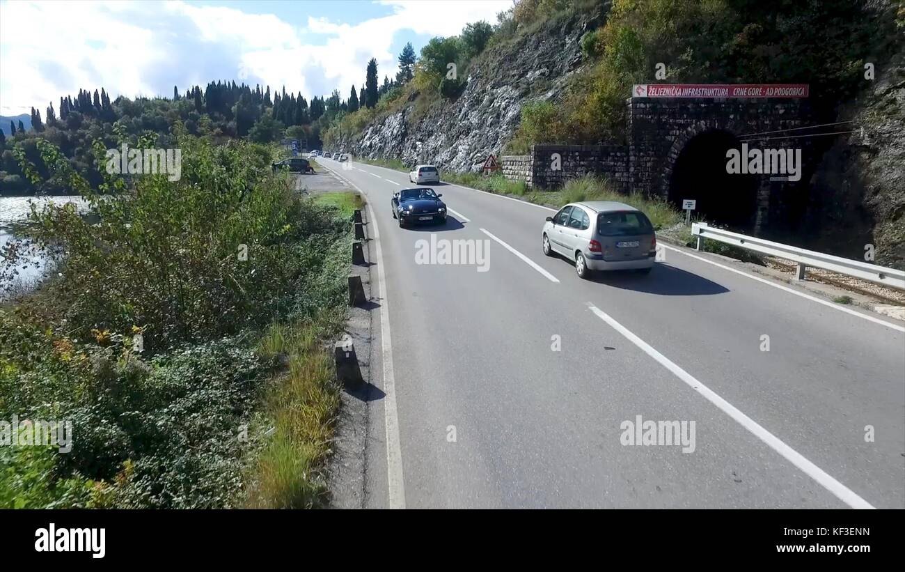 Car going on a road near the river, aerial view. Footage. Aerial view ...