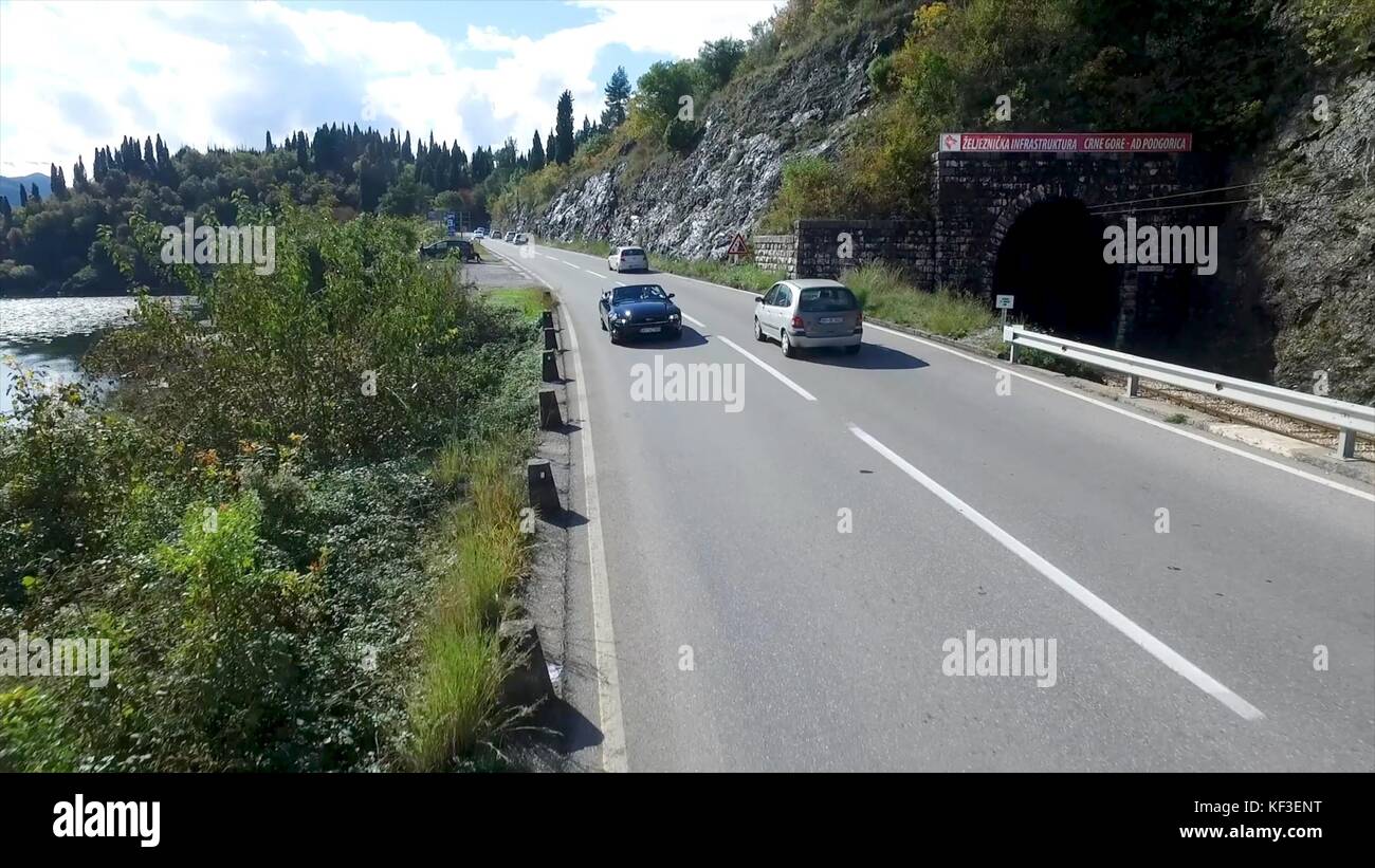 Car going on a road near the river, aerial view. Footage. Aerial view ...