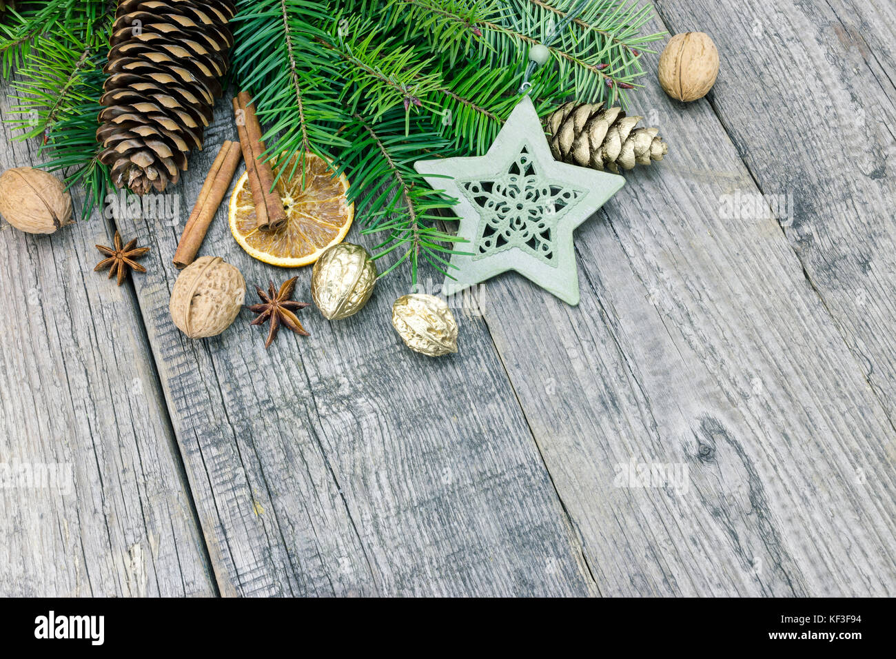 fir tree branches with spiced fruit, cinnamon sticks and nuts on ...