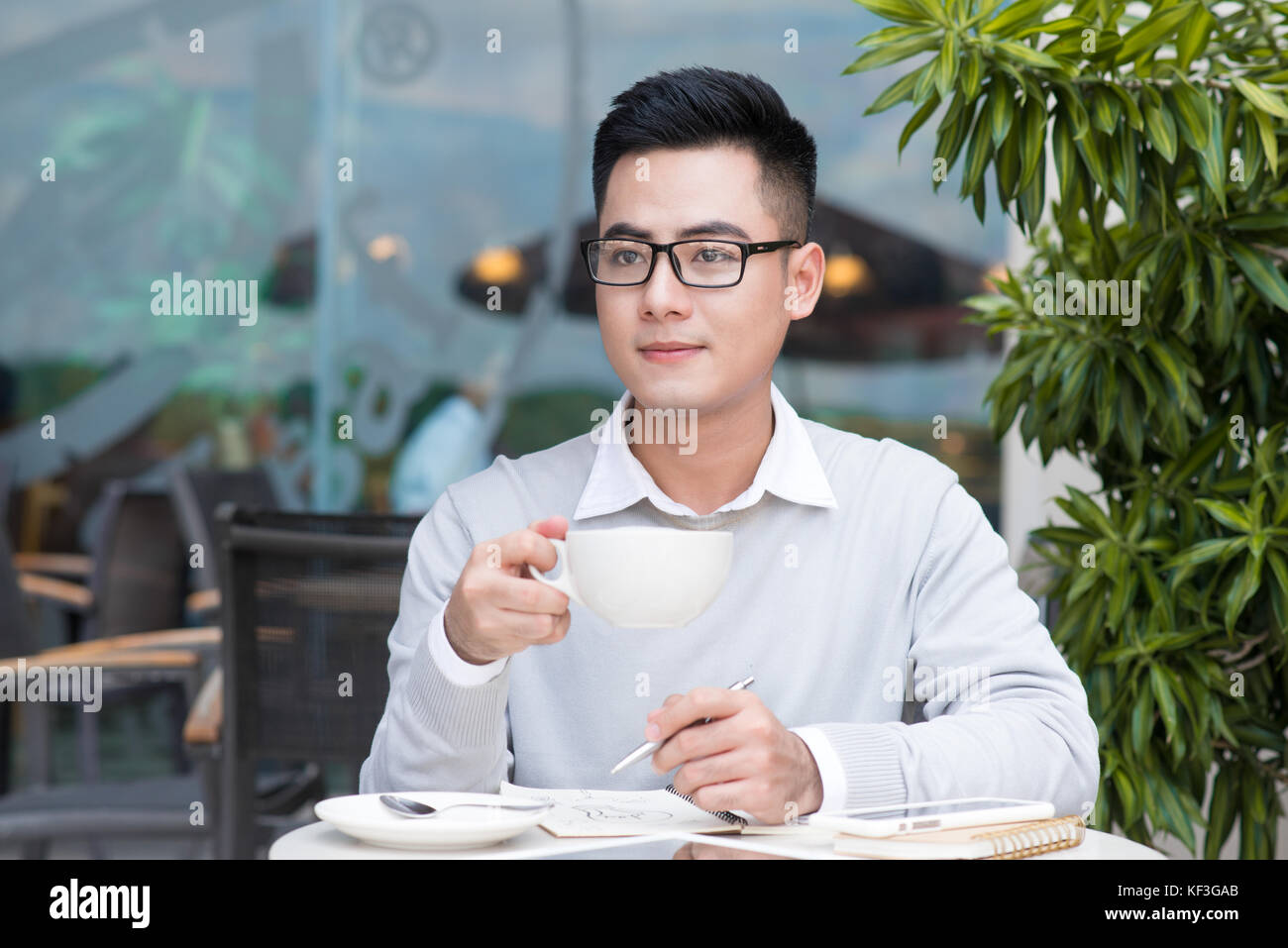 Handsome young man drinking coffee at city Stock Photo - Alamy