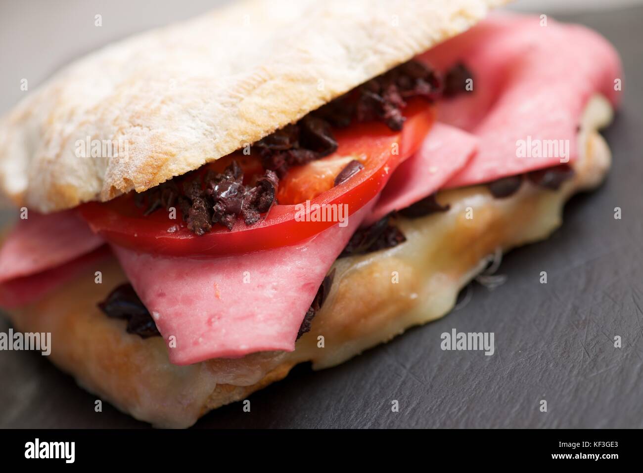 Mortadella sandwich, tomato and black olives Stock Photo - Alamy