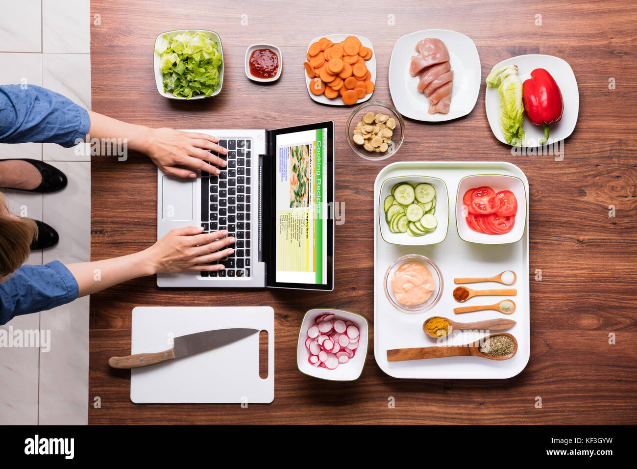 Woman looking recipe on laptop hi-res stock photography and images - Alamy