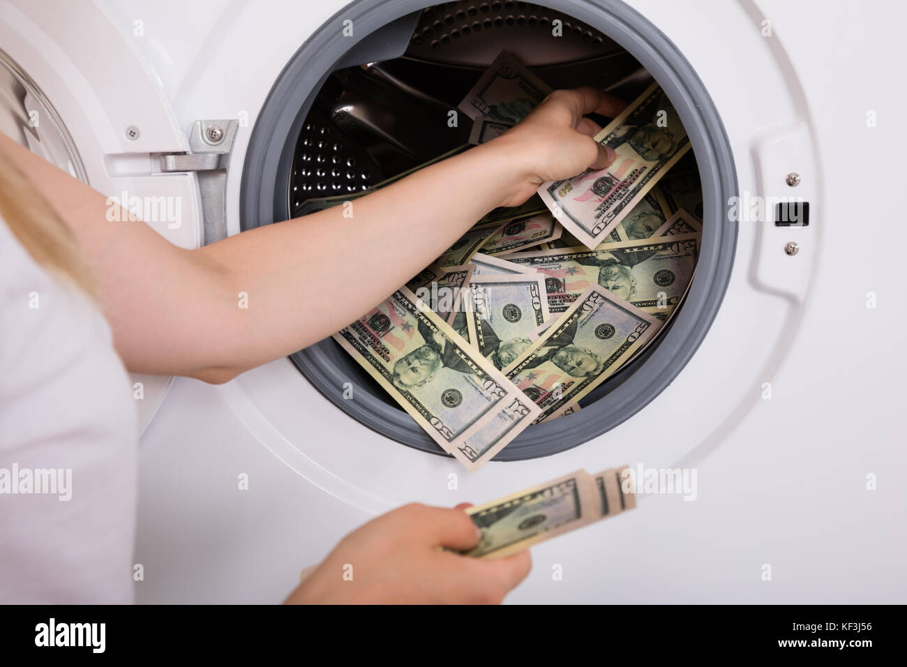 Close-up Of Person Hand Inserting Dirty Money In Washing Machine Stock ...