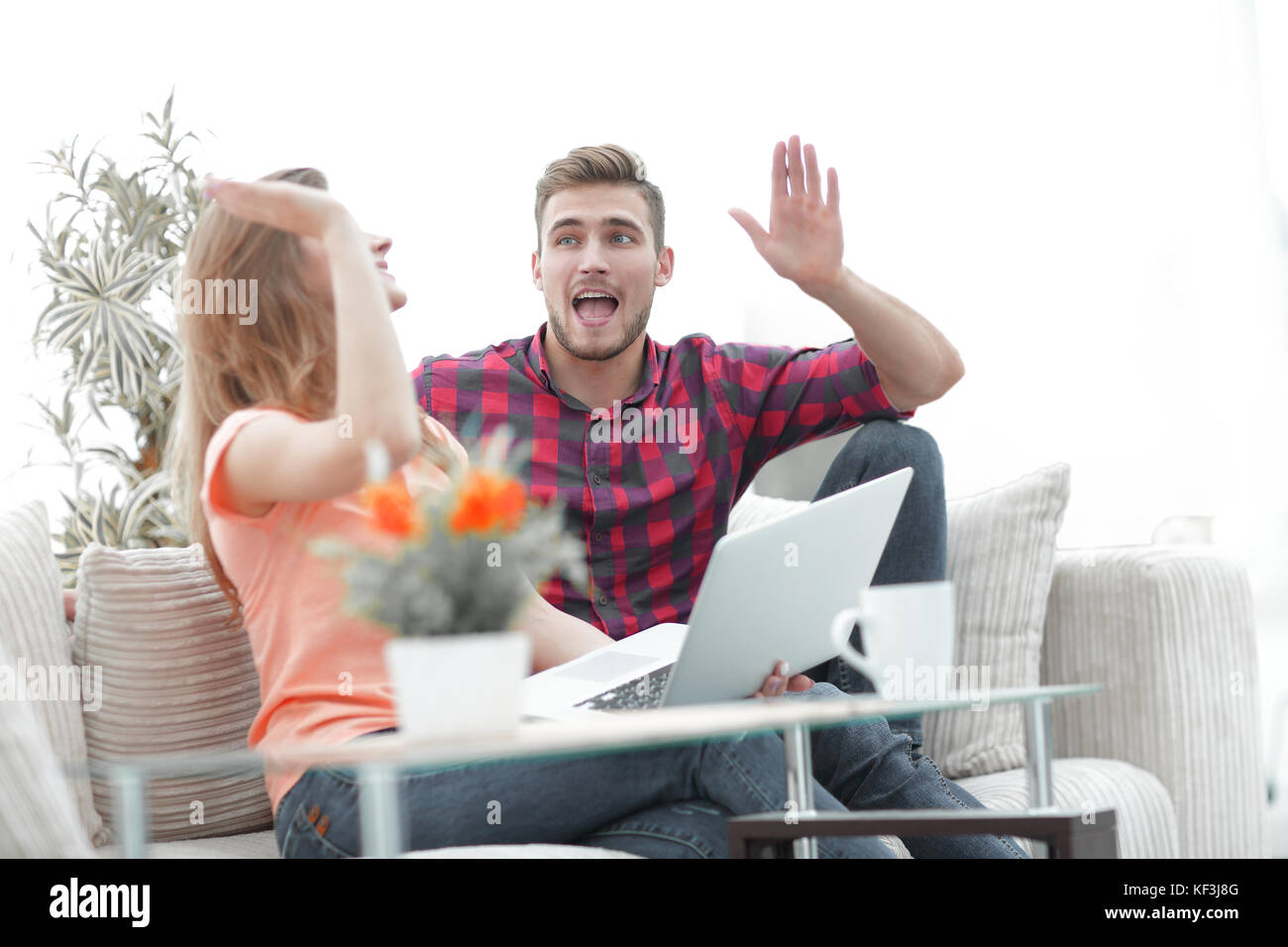 happy young couple giving each other a high five Stock Photo - Alamy