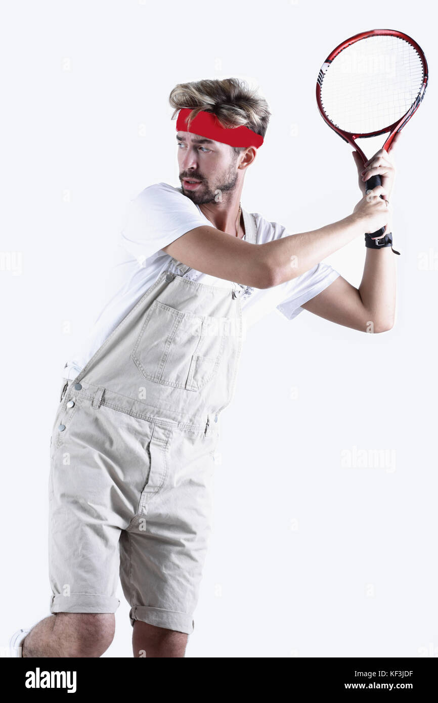 Male tennis player with racket in action Stock Photo - Alamy