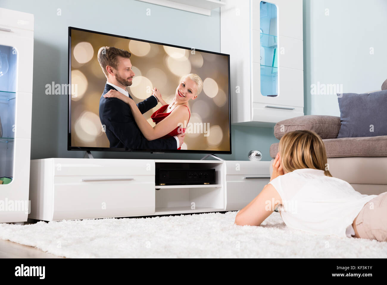 Beautiful lady watching tv lying hi-res stock photography and images ...