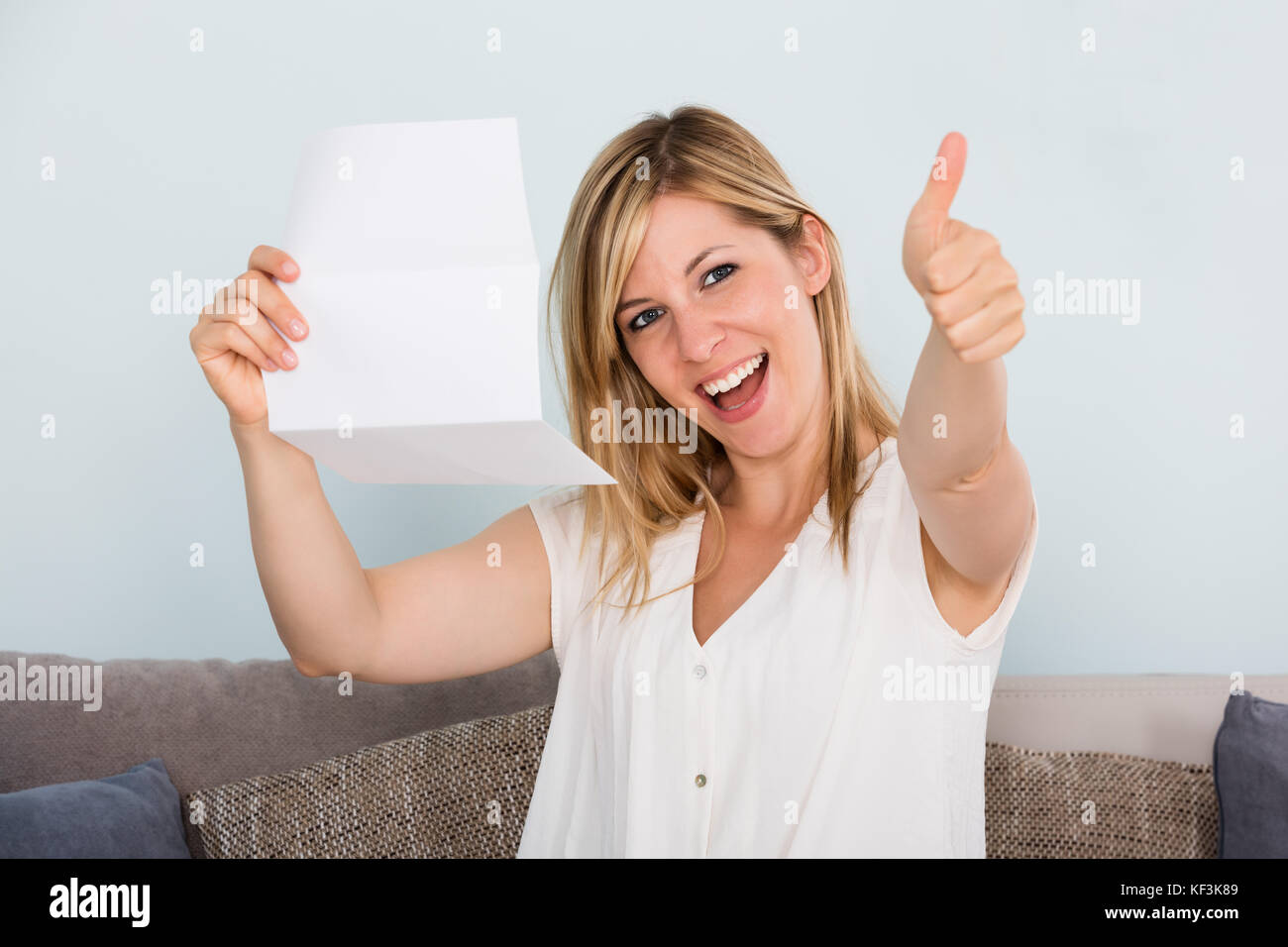 Portrait Of A Smiling Young Woman Reading Letter Stock Photo - Alamy
