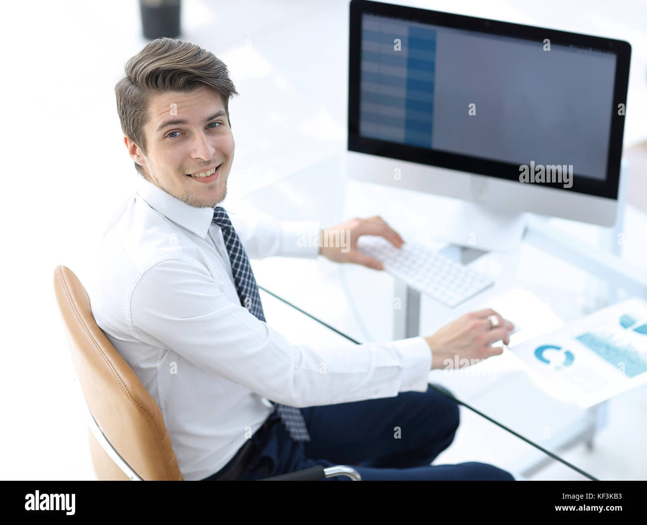 successful employee sitting in front of a computer screen.photo with ...
