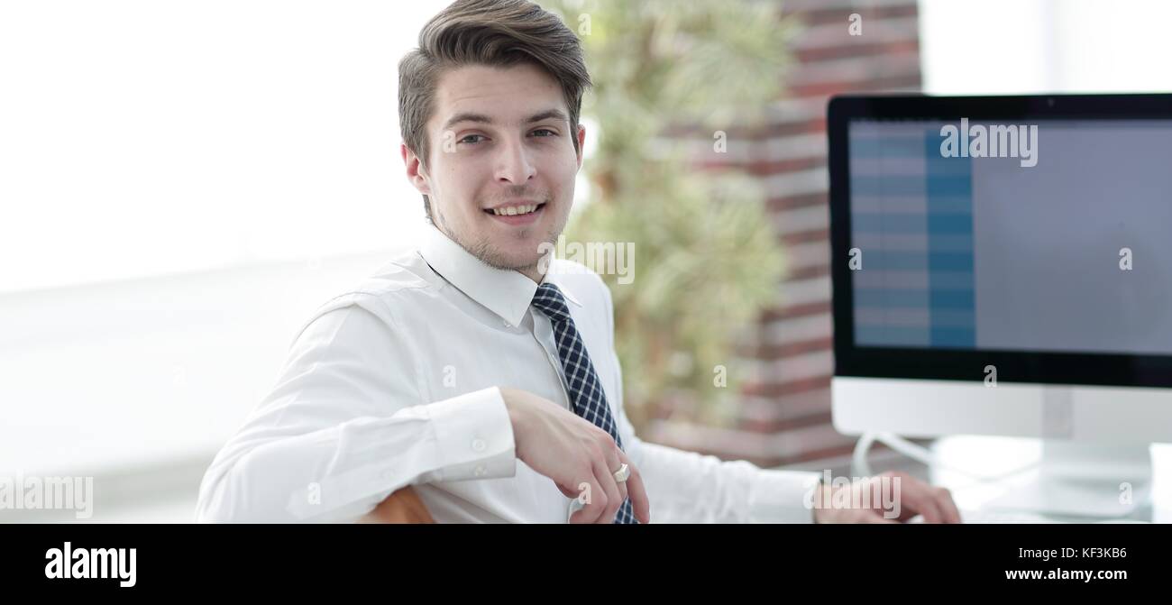 employee sitting in front of a computer screen Stock Photo - Alamy