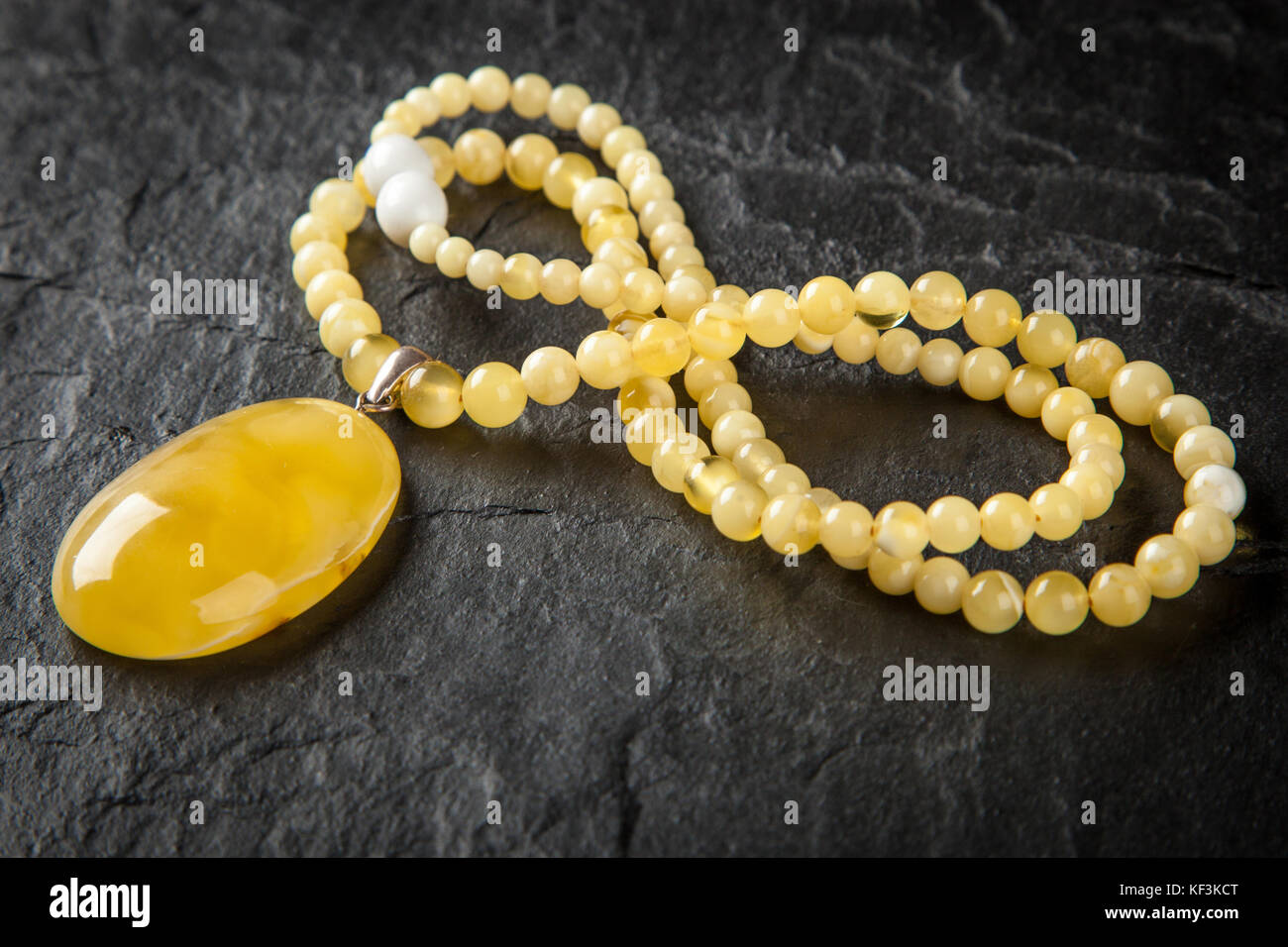 Amber jewelry on grey background Stock Photo - Alamy