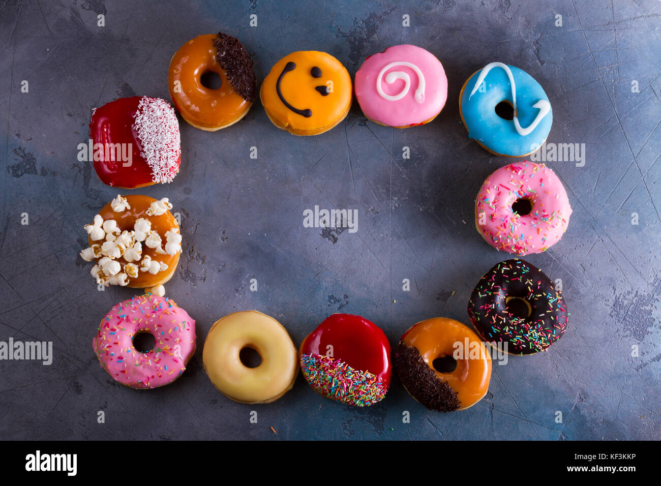 sweet doughnuts on gray stone background Stock Photo - Alamy