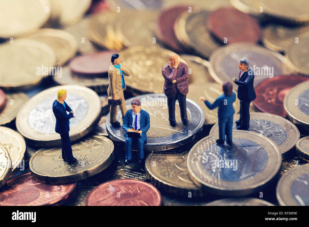 group of business people standing on euro money stack and talking Stock ...