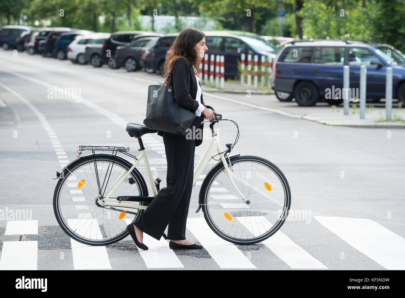 Side View Of Young Smiling Businesswoman With Handbag Commuting On ...