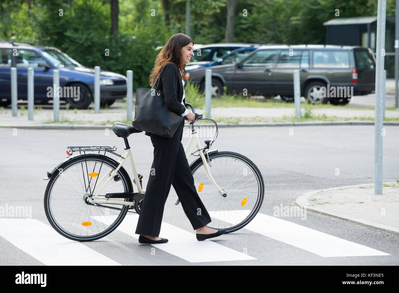 Side View Of Young Smiling Businesswoman With Handbag Commuting On ...