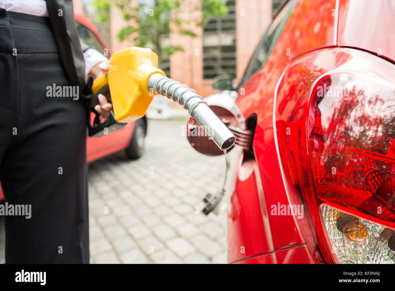 Close-up Of Businesswoman's Hand Refueling Car's Tank By Holding Petrol ...