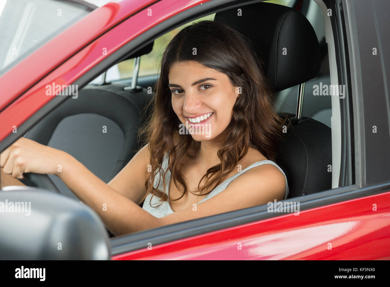Side View Of A Young Happy Woman Driving Car Stock Photo - Alamy