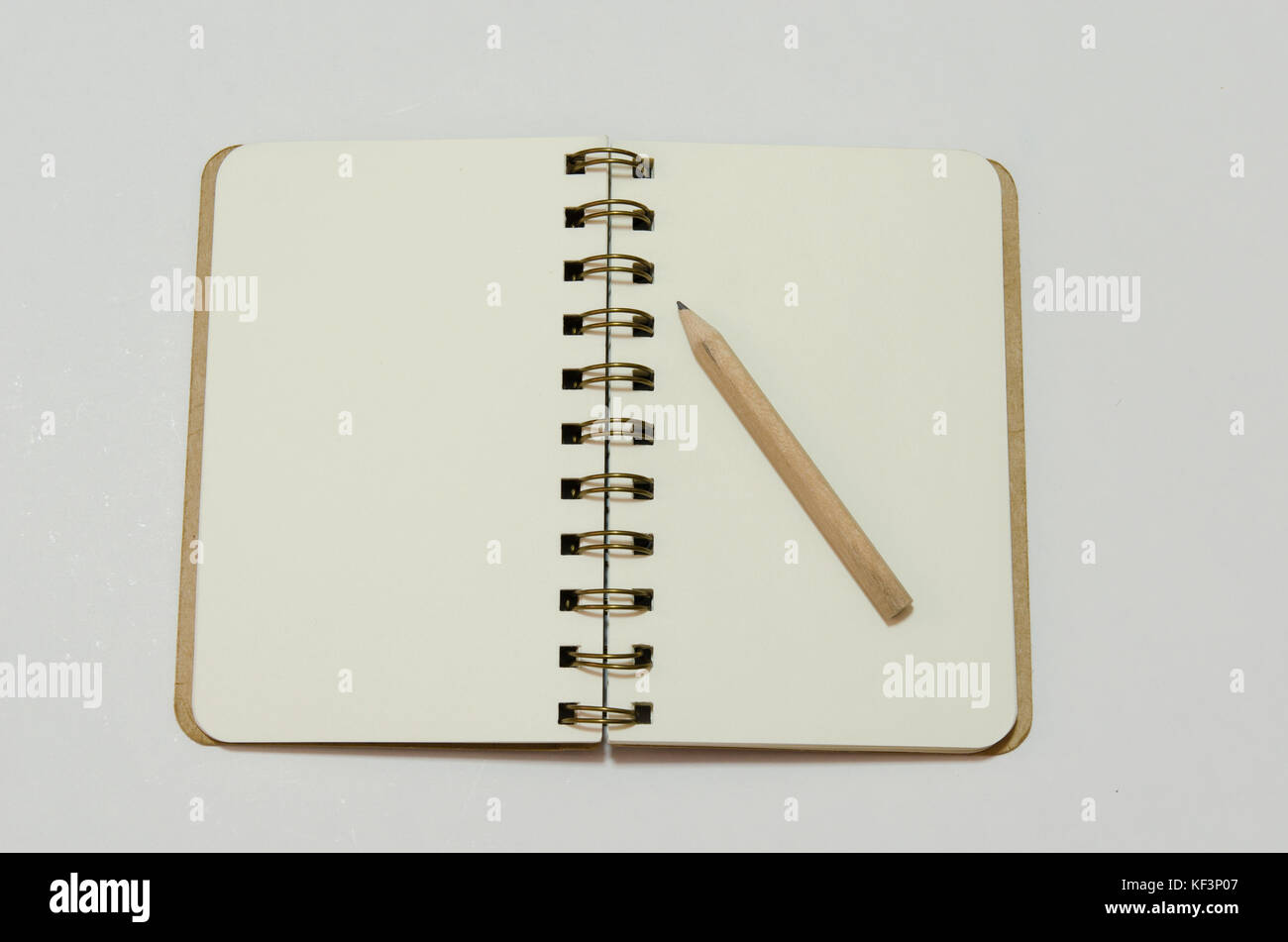 Empty notebook paper and pencil on white background Stock Photo - Alamy