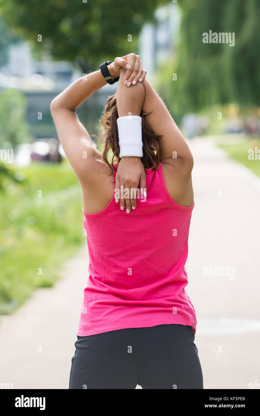Rear View Of Sporty Young Woman Doing Morning Exercise In Park Stock ...