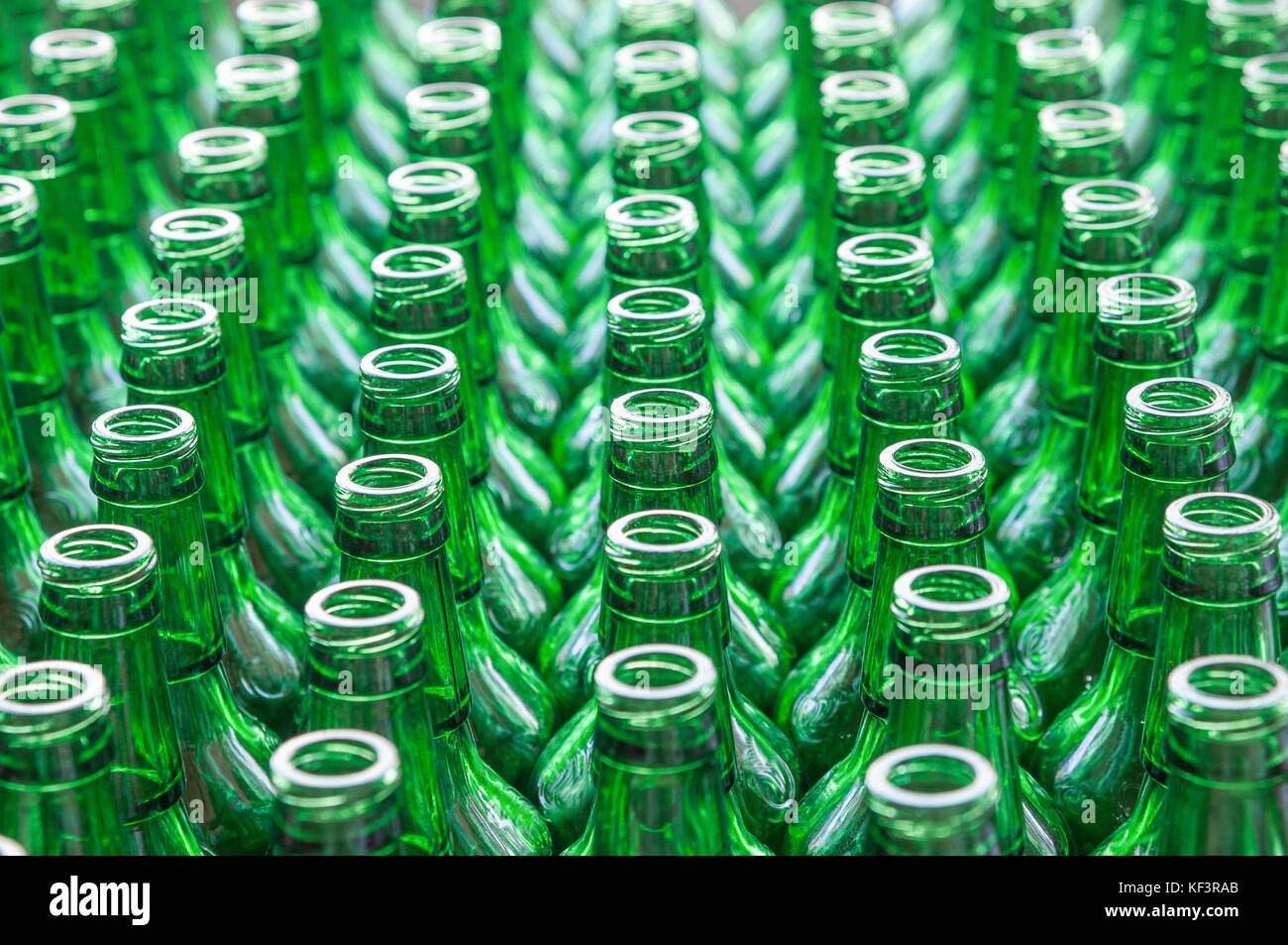 a large number of transparent glass bottles of green color closeup ...