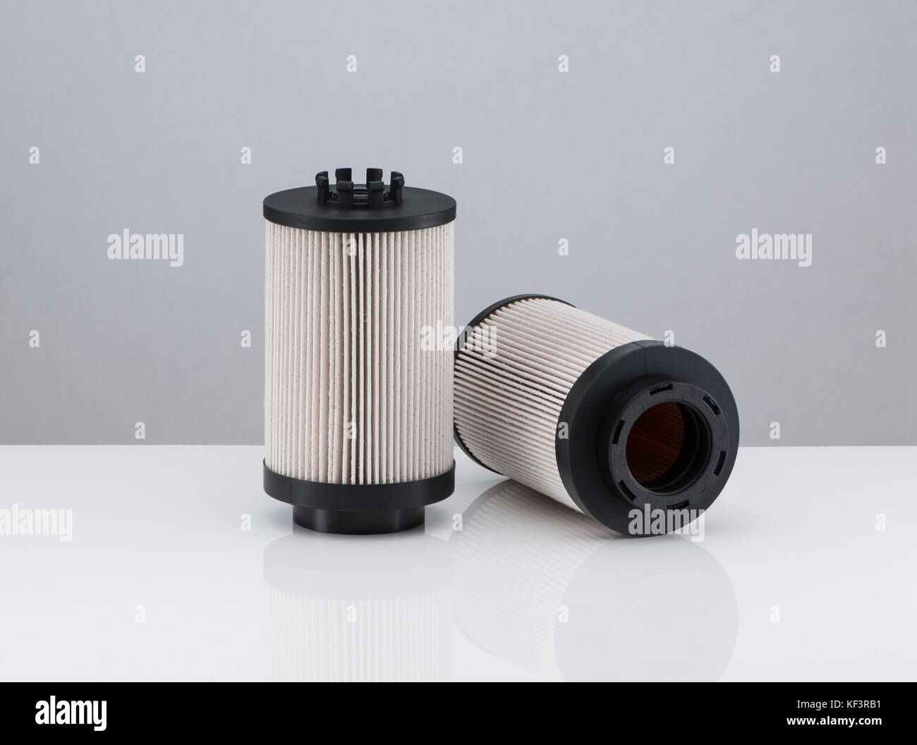 two automotive filter cylindrical shape on a white background with ...