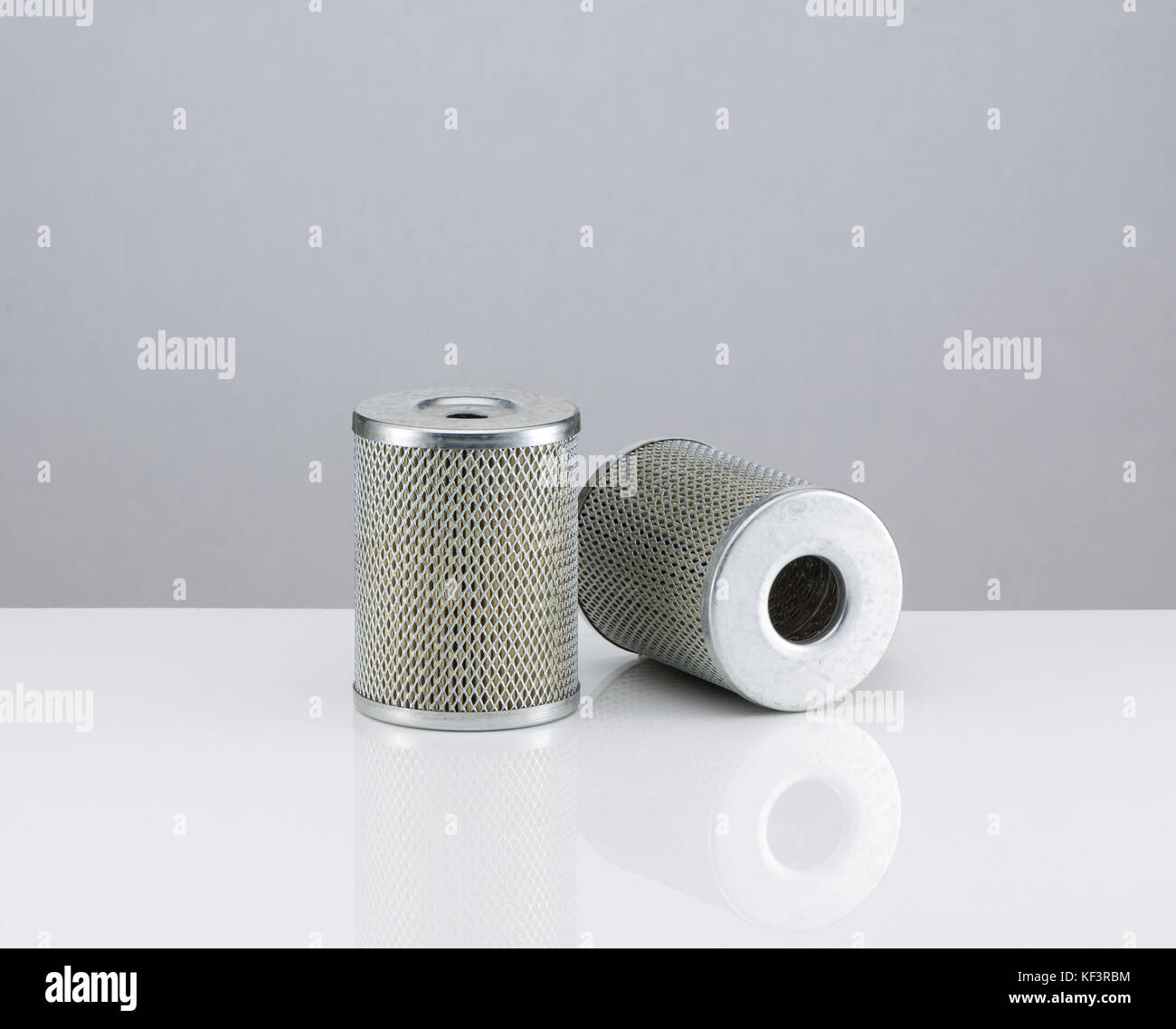 two automotive filter cylindrical shape on a white background with ...