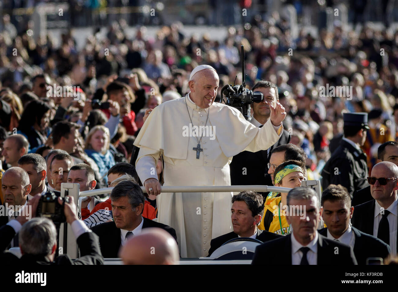 Pope Francis rides on the Popemobile through the crowd of the faithful ...