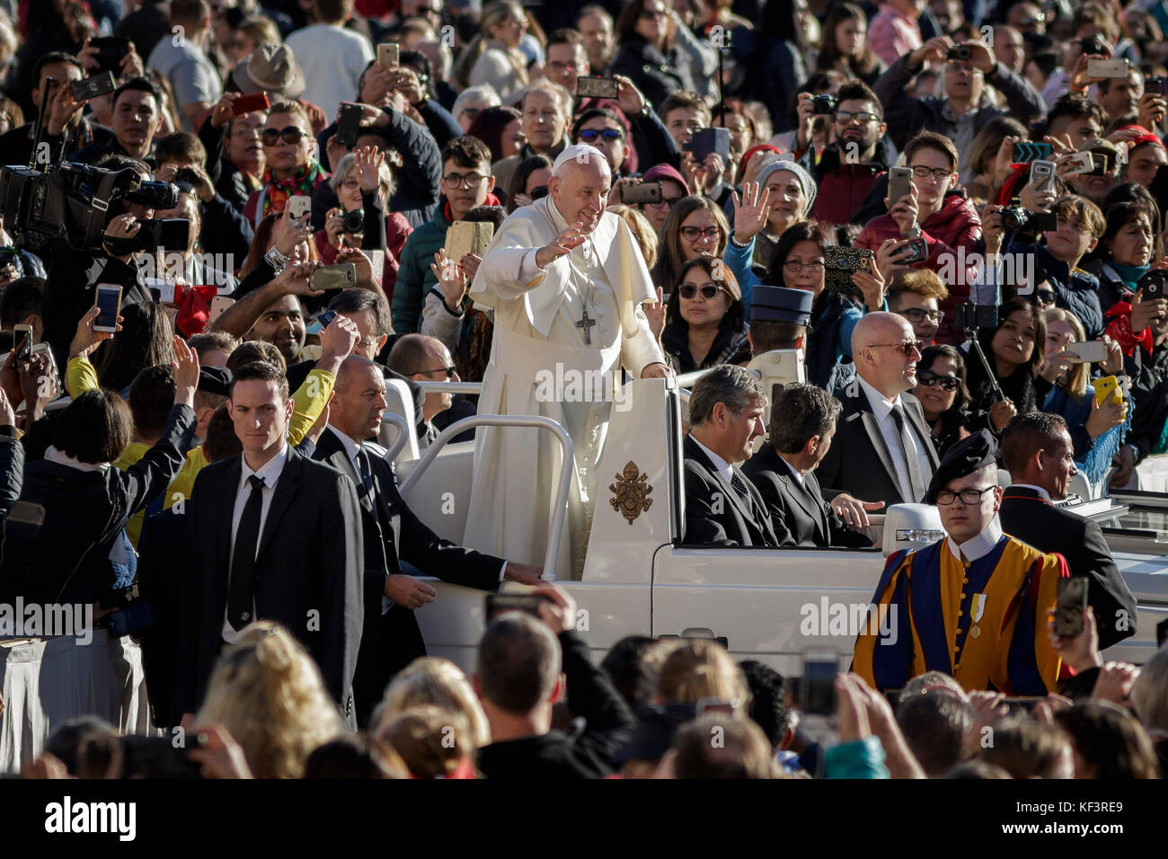 Pope Francis rides on the Popemobile through the crowd of the faithful ...