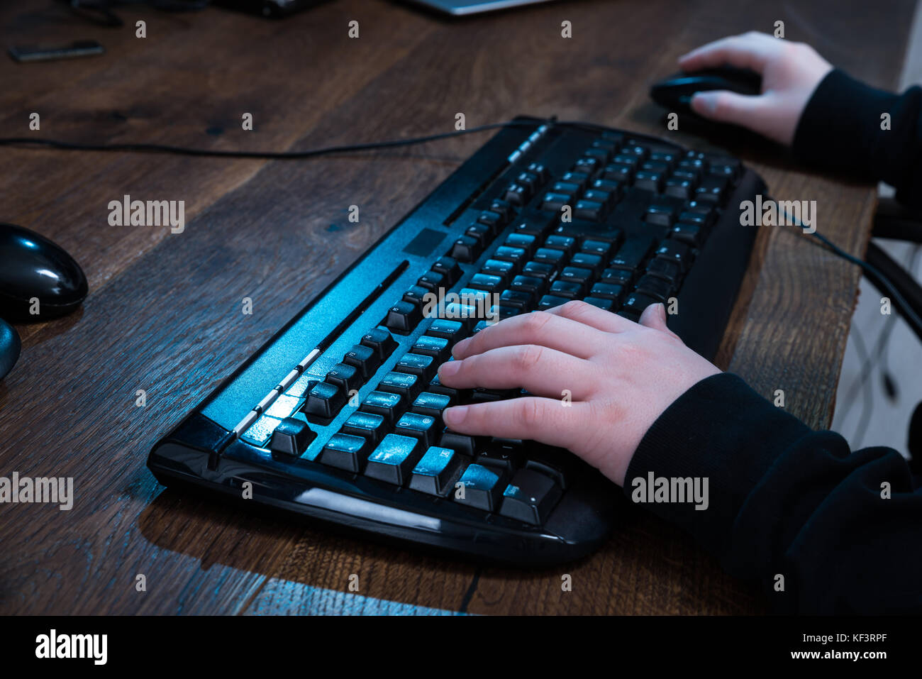 Close-up Of A Boy Using Keyboard On Desk Stock Photo - Alamy
