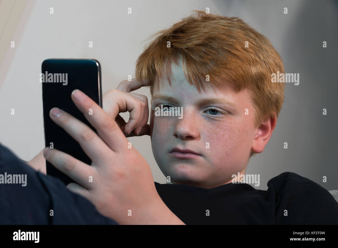 Close-up Photo Of A Boy Using Cellphone Stock Photo - Alamy