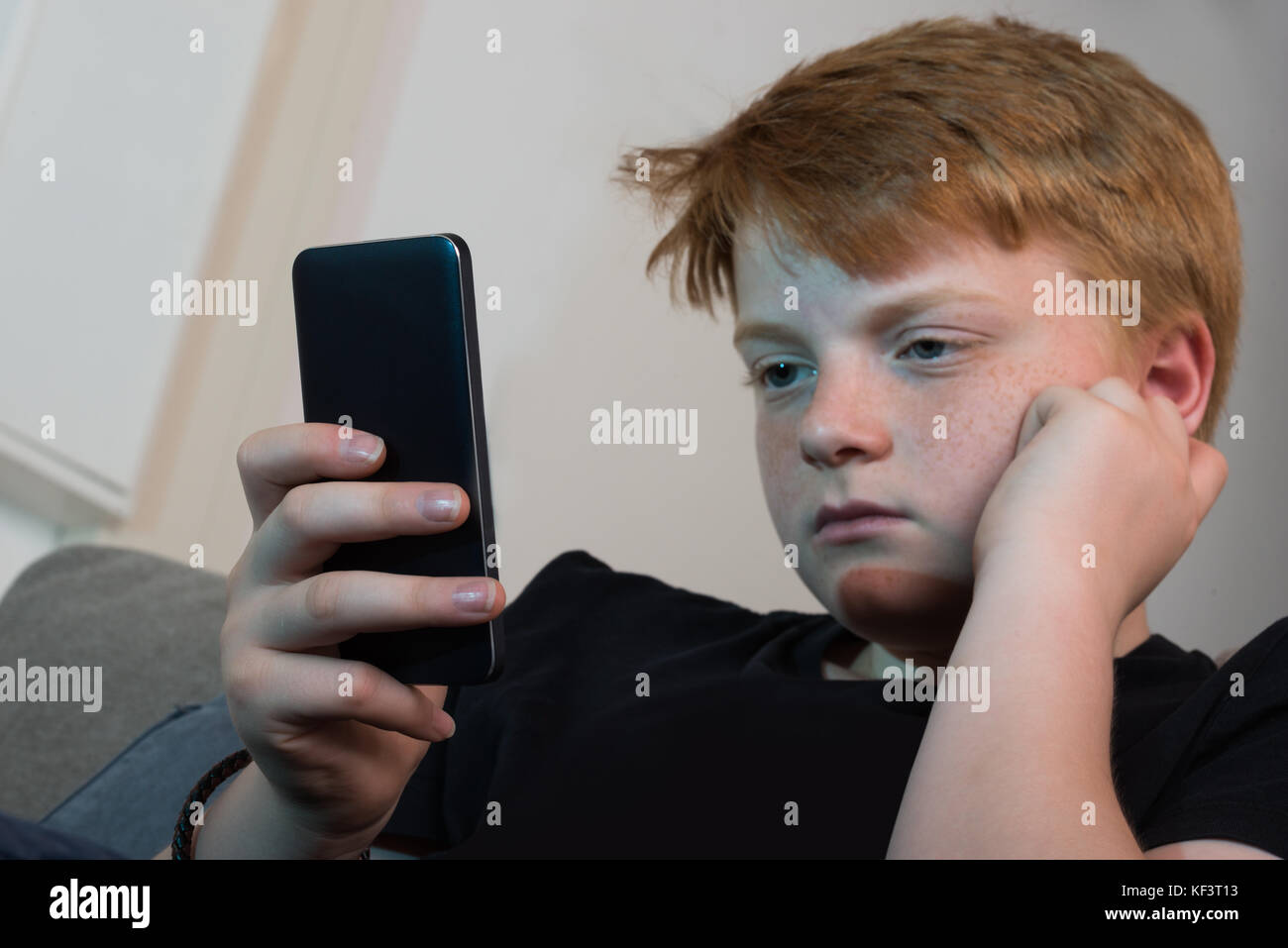 Close-up Photo Of A Boy Using Cellphone Stock Photo - Alamy