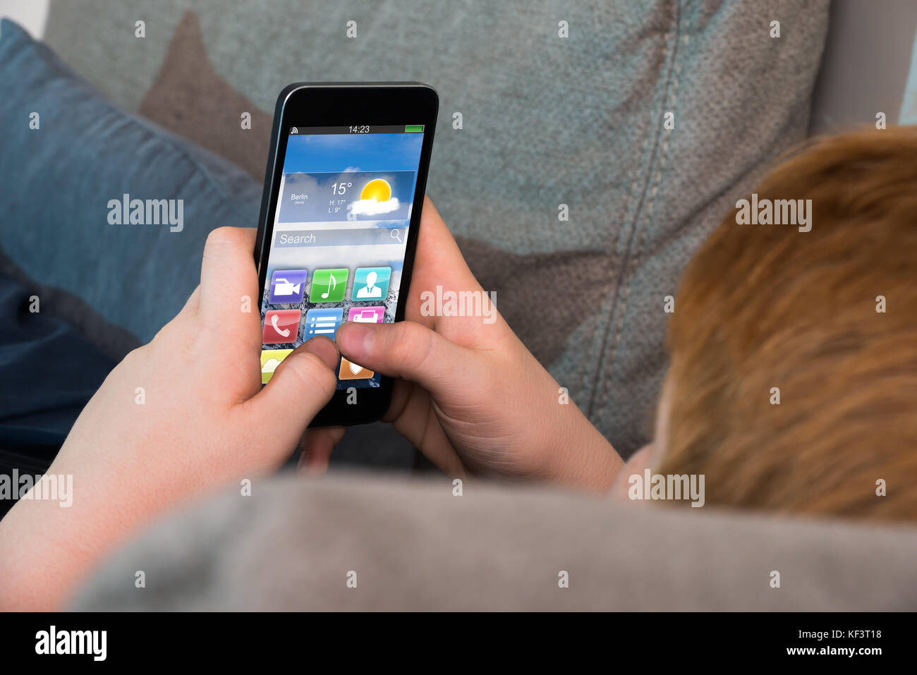 Boy Using Mobile Phone With Multicolored App On Screen Stock Photo - Alamy