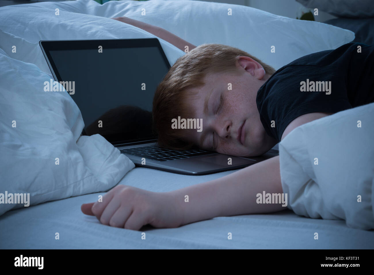 Child Sleeping On Bed With His Laptop Stock Photo - Alamy