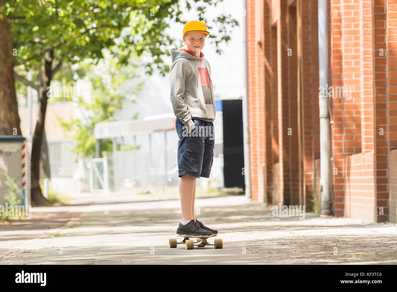 Portrait Of A Smiling Boy Riding Skateboard Stock Photo - Alamy