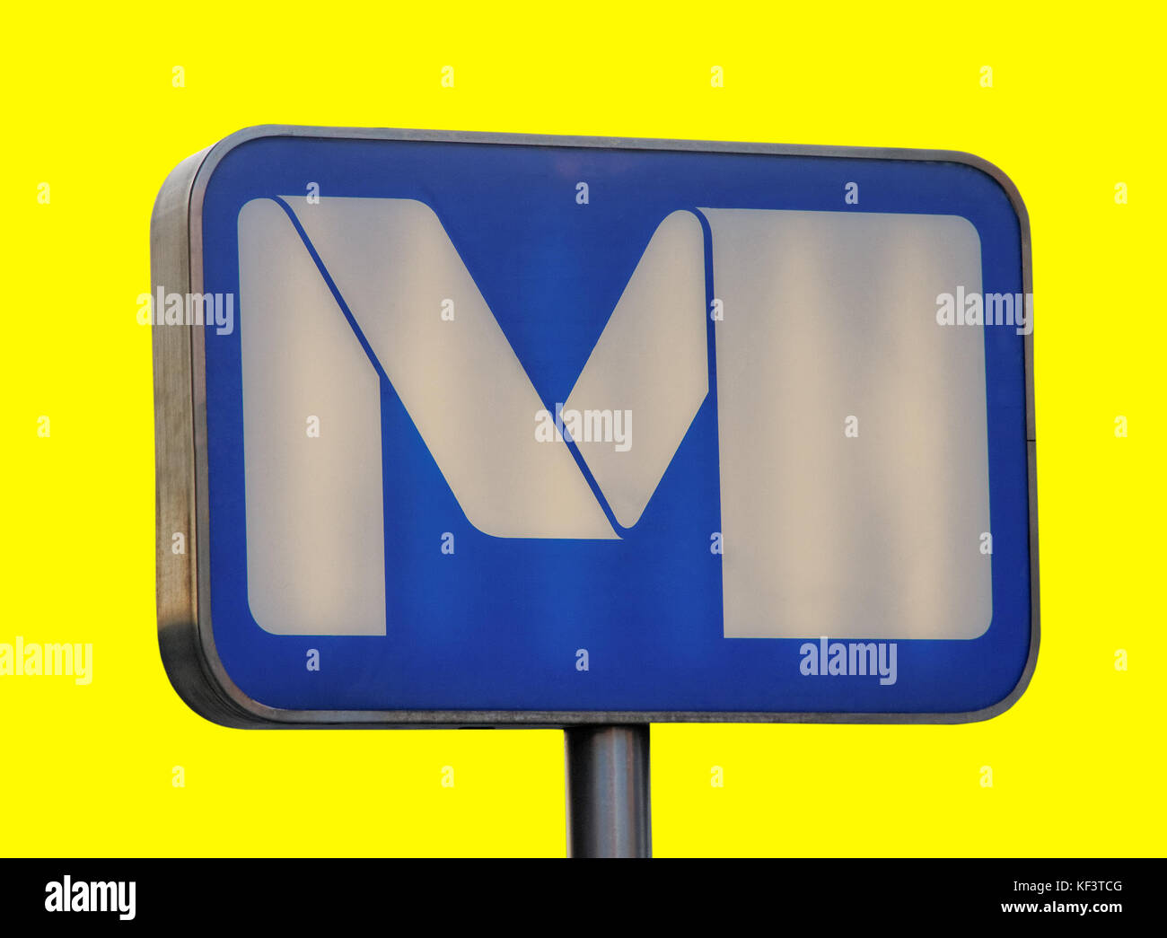 Metro station sign isolated on yellow surface Stock Photo - Alamy