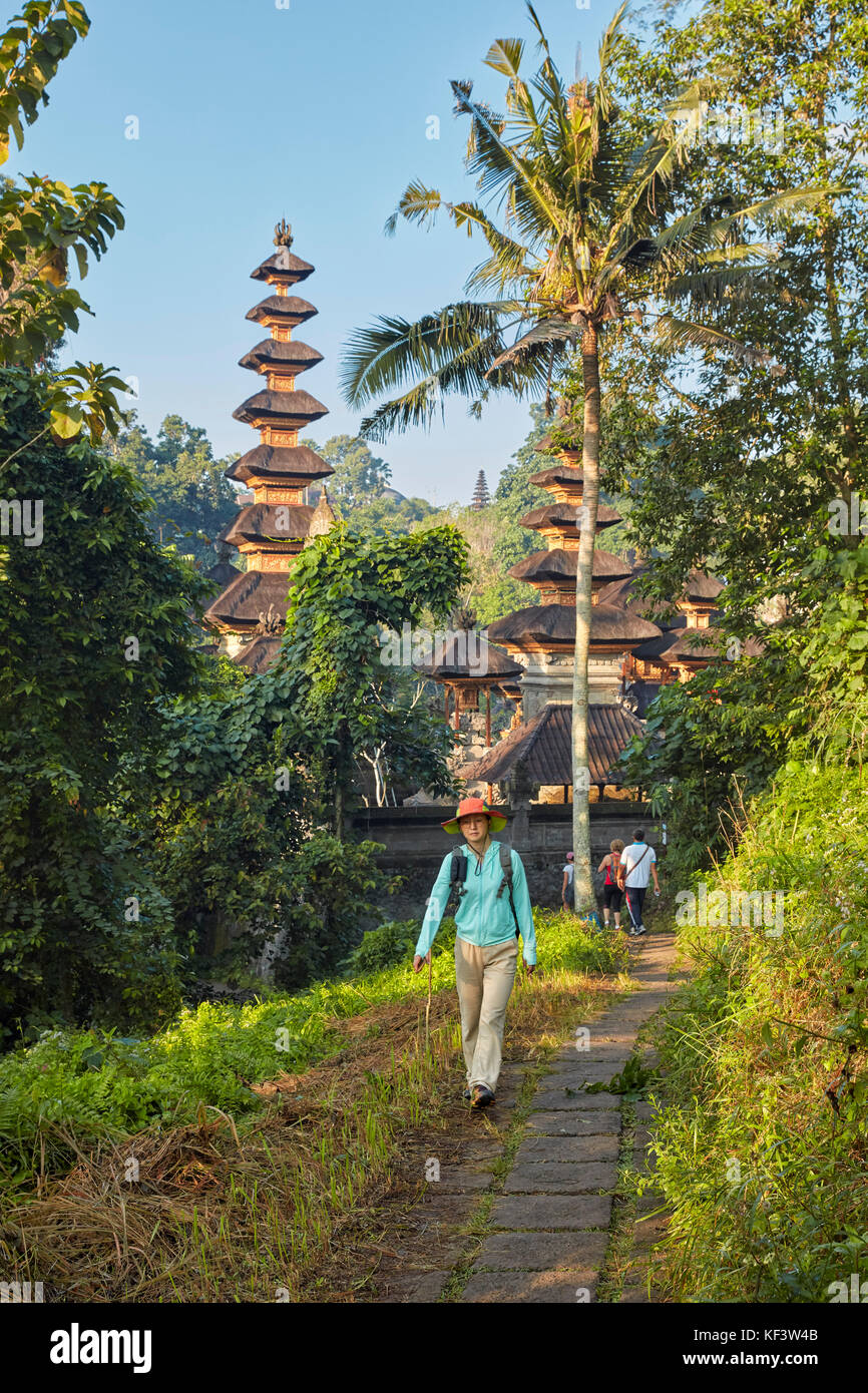 A tourist walks along the Campuhan Ridge Walk in the morning. Ubud ...
