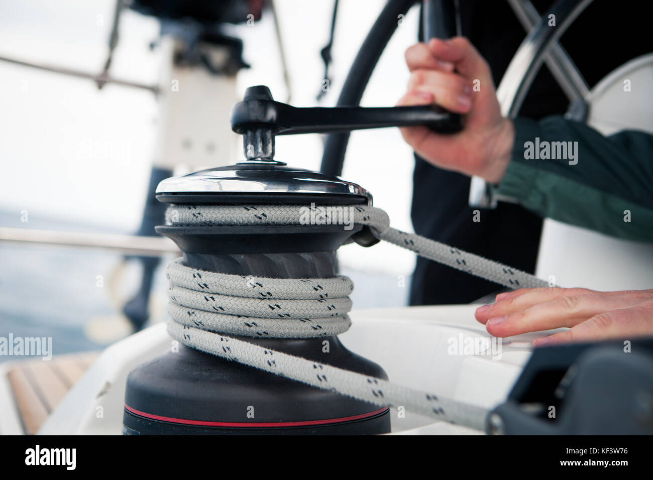 Sailor pulling rope, outdoor activities, sailboat sport race, man in ...