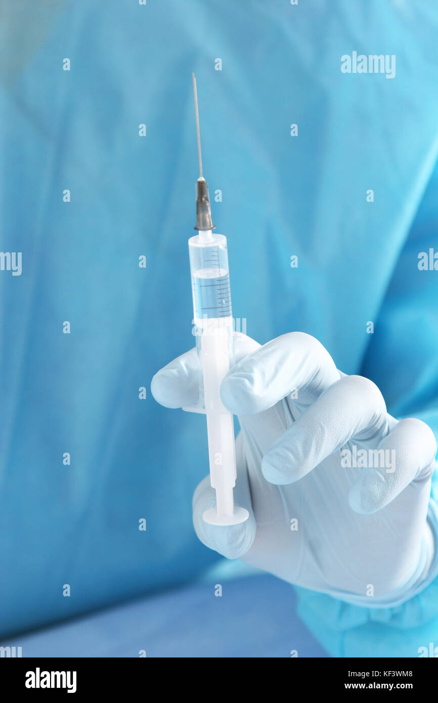 Syringe, medical injection in hand, palm or fingers. Medicine plastic ...