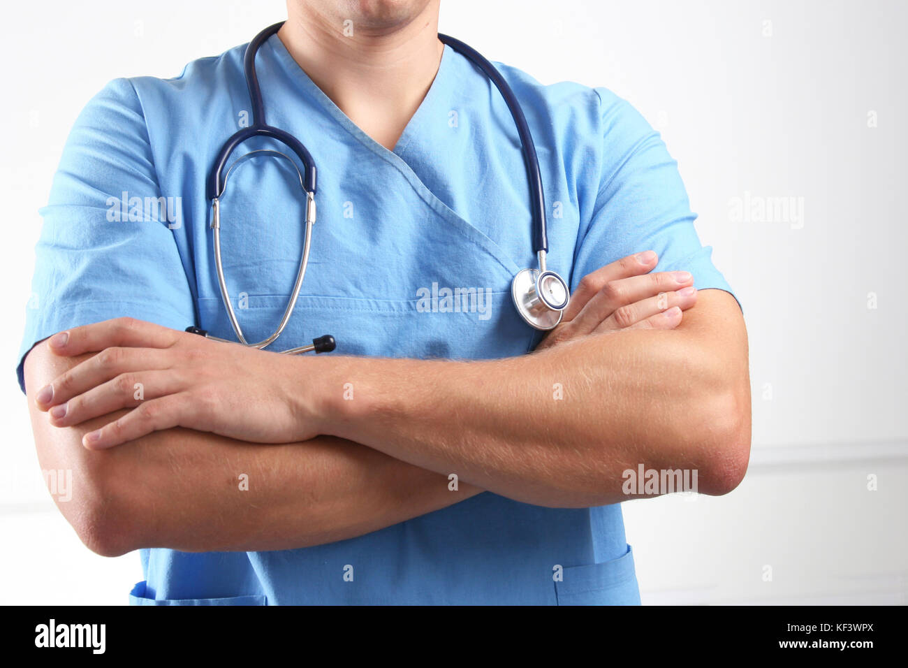 Portrait of a doctor with stethoscope standing isolated on white ...