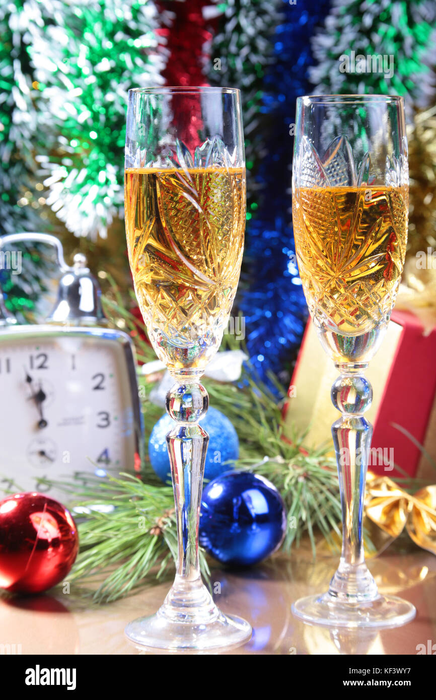 Glass of sparkling shampagne wine clock and gift box on christmas ...