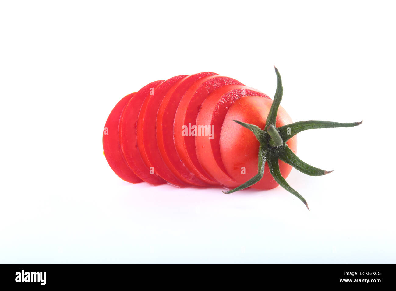 sliced fresh tomatoes with green leaves isolated on white background ...
