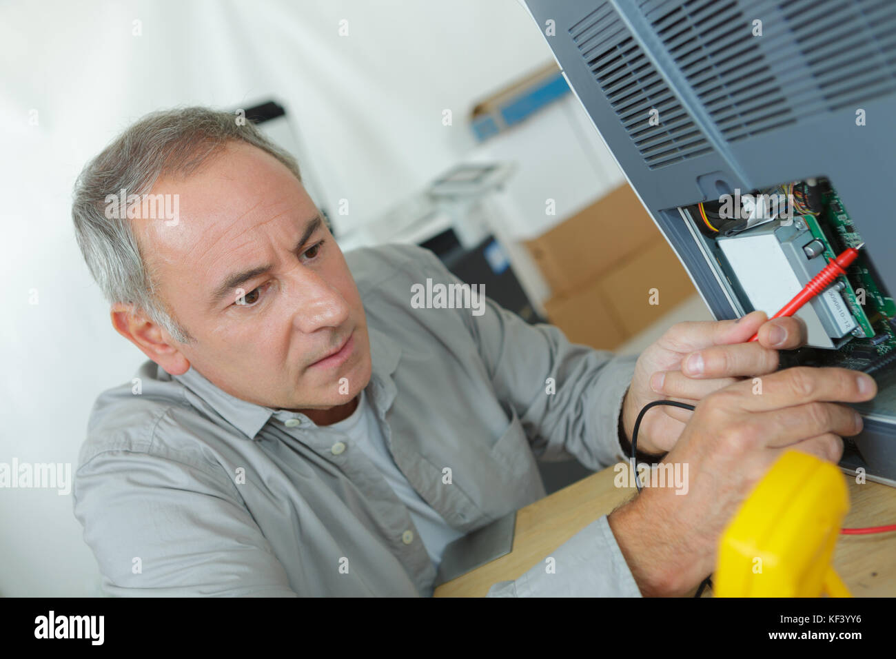 senior worker calibrating a machine Stock Photo - Alamy