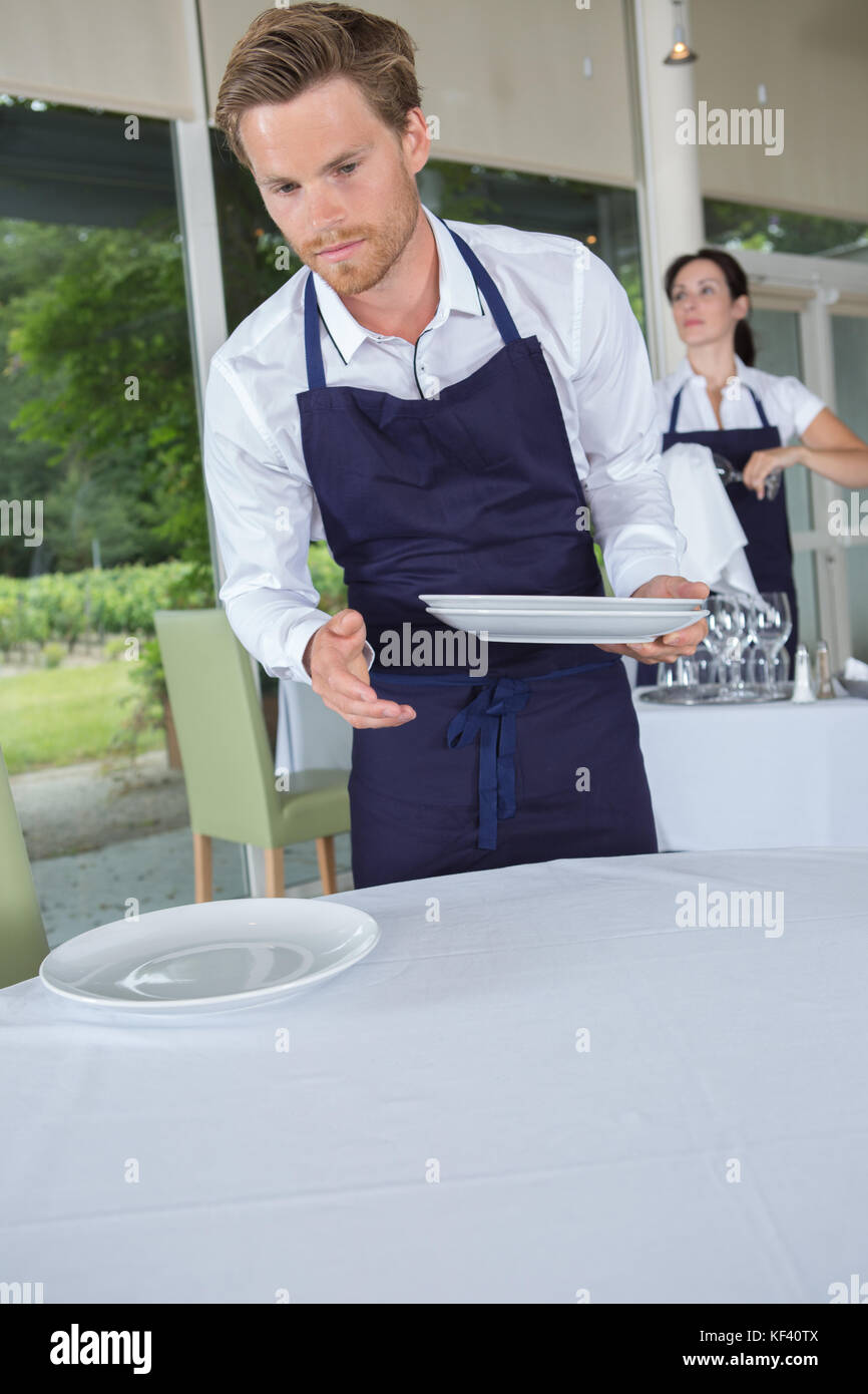 server in the restaurant holding the plates Stock Photo - Alamy